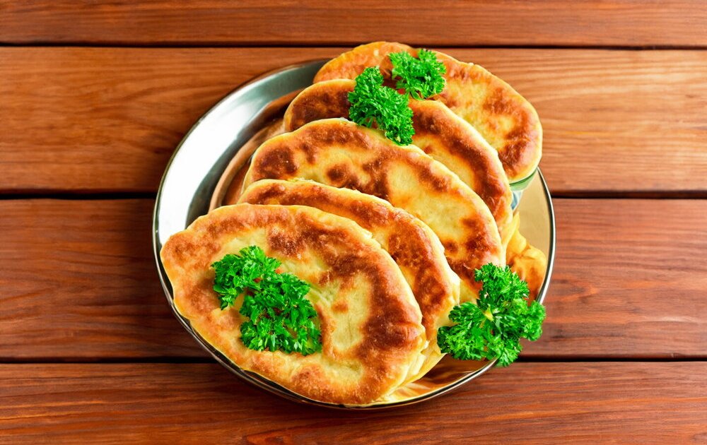 Thin Fried Pies with Potatoes in a Pan